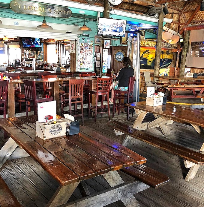 Weathered wood tables and fishing memorabilia create the kind of atmosphere where every meal feels like a celebration.