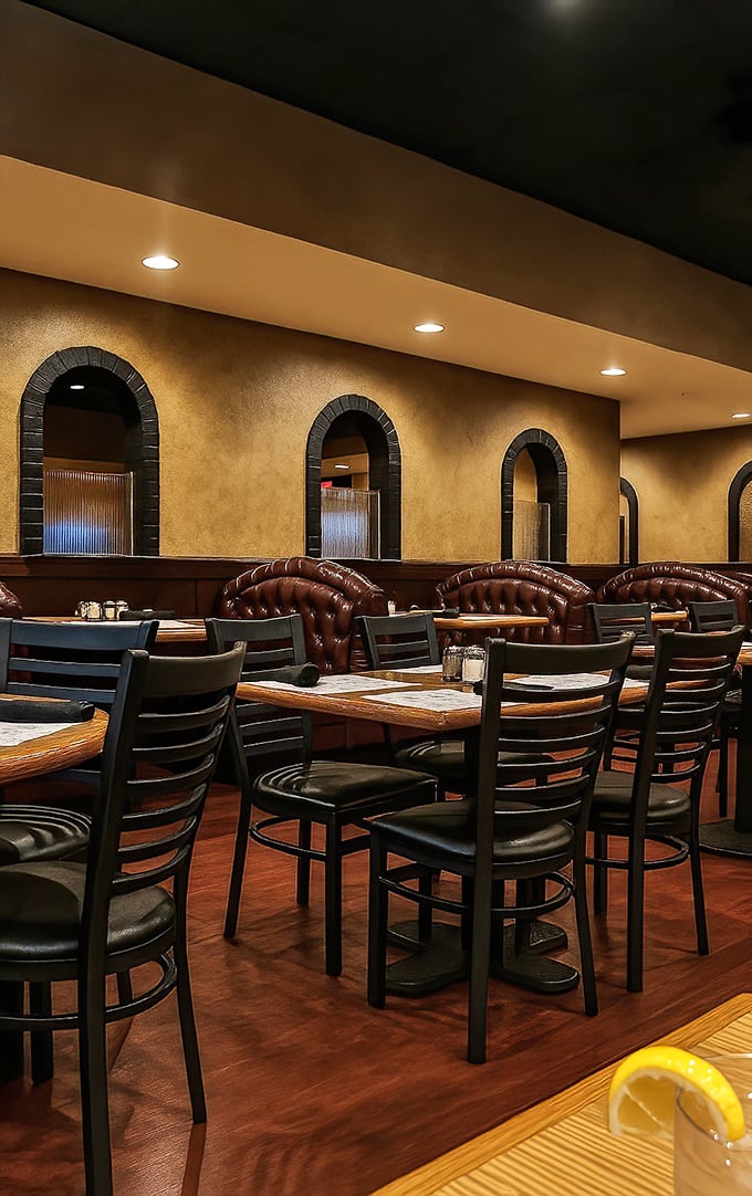 Step inside to find that perfect balance of cozy and elegant—golden walls, arched alcoves, and leather booths create an atmosphere where both first dates and family reunions feel right at home.