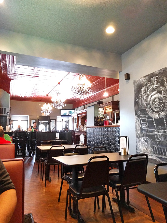Step inside to discover the unexpected elegance of red tin ceilings, crystal chandeliers, and that impressive locomotive mural—small-town Indiana meets metropolitan charm.