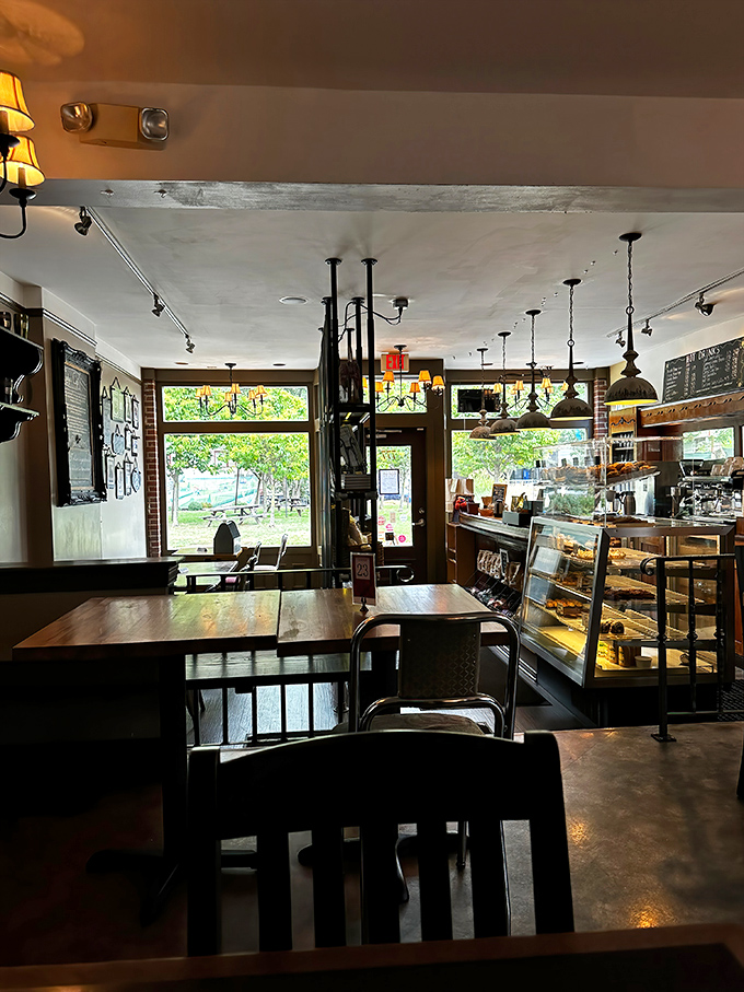 Inside, rustic charm meets industrial cool with exposed brick, wooden tables, and pendant lighting that makes everyone look like they just returned from vacation.