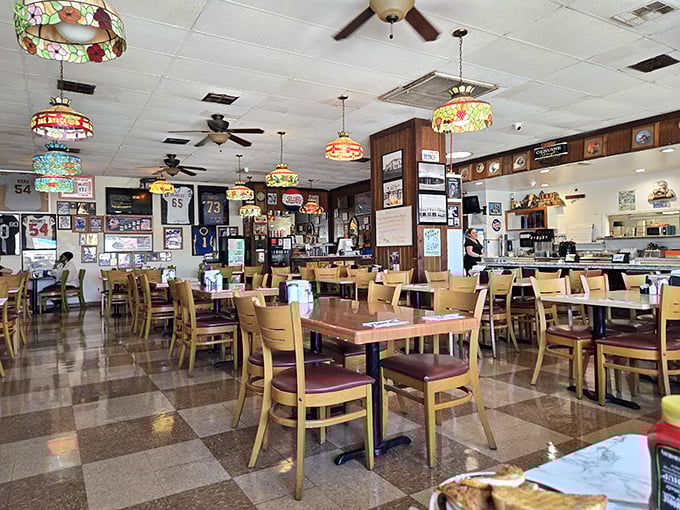 Step inside and the classic diner aesthetic hits all the right notes—checkerboard floors, stained glass pendant lamps, and walls that tell the story of a community.