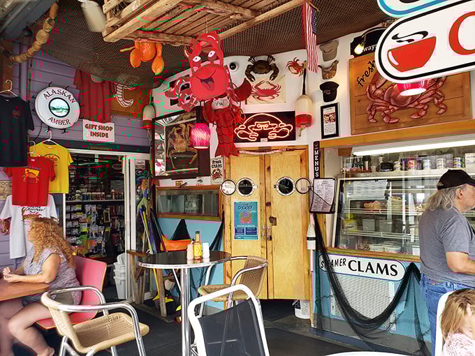 Step inside seafood heaven, where dangling crabs, fishing nets, and maritime memorabilia create the perfect backdrop for your coastal feast.