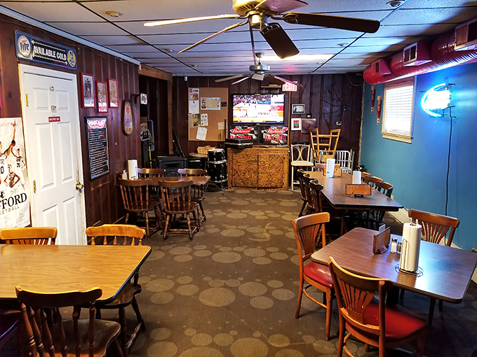 Where wood paneling isn't a design choice but a witness to decades of satisfied sighs. The ceiling fans spin stories almost as good as the locals.