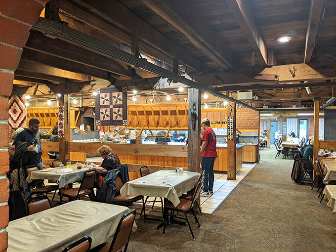 Exposed wooden beams and quilted wall hangings aren't trendy design choices here—they're authentic pieces of Ohio heritage holding decades of dining memories.