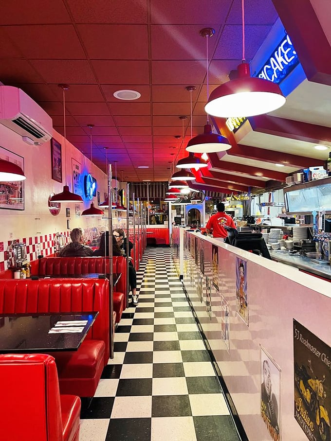 Where neon meets nostalgia. The cherry-red booths and checkerboard floor aren't just design choices—they're time machines to when calories didn't count.