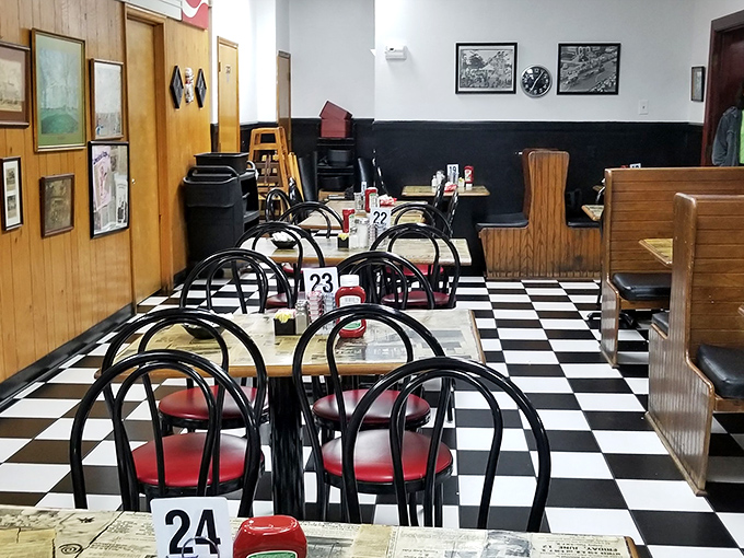 Classic black and white checkered floors set the stage for culinary time travel. This isn't retro-styled—it's authentically unchanged because it was perfect the first time.