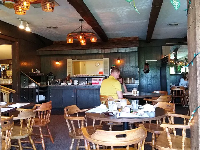 Inside, wooden beams and warm lighting create the kind of cozy atmosphere that makes you want to settle in, loosen your belt, and forget about that diet you were considering.