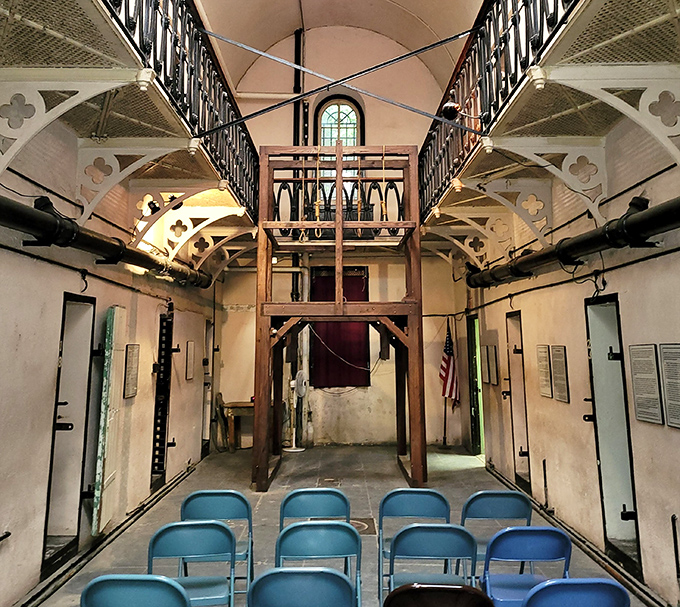 Cell Block One's tiered design seems oddly beautiful until you remember its purpose—like admiring the engineering of a Venus flytrap while you're stuck inside it.