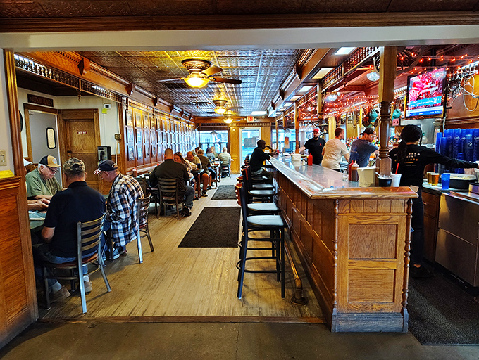 Step inside and time slows down – the warm wood paneling, classic bar, and ornate tin ceiling create the kind of authentic atmosphere money can't manufacture.