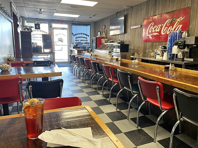 Classic black and white checkered floors, wood paneling, and red vinyl stools—this isn't retro-chic design, folks, this is the real deal that chains try desperately to replicate.