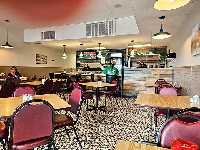 Inside, burgundy chairs and mosaic floors create that perfect diner atmosphere – where conversations flow as freely as the coffee refills.