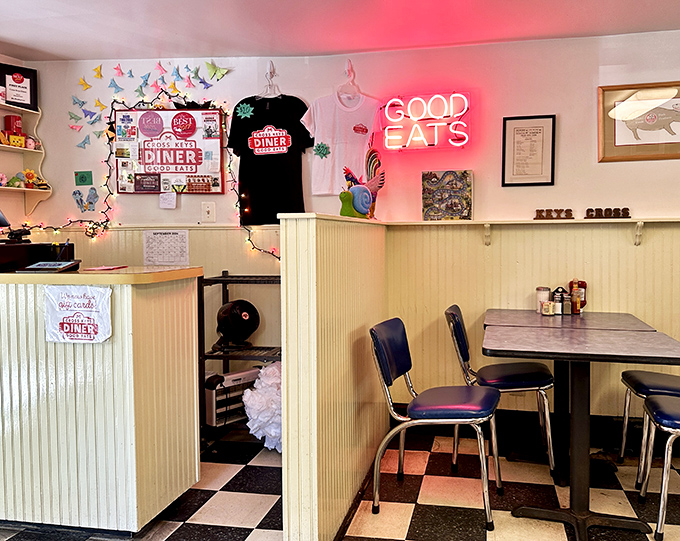 Step inside to a world where colorful paper butterflies dance above cream wainscoting, and that neon "GOOD EATS" sign isn't just decoration—it's truth in advertising.