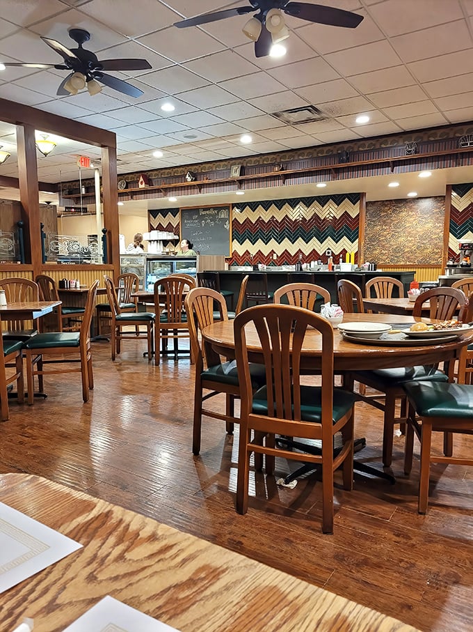 Wooden chairs, warm lighting, and that distinctive zigzag wall pattern – this isn't interior design, it's breakfast ambiance perfected over decades.