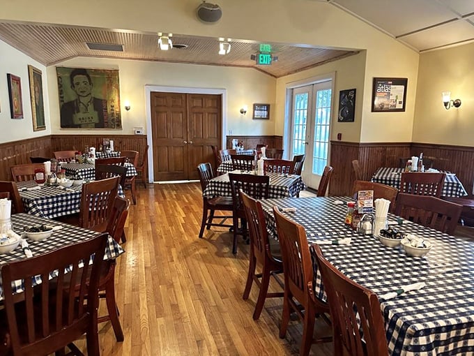 Classic wooden chairs, black and white checkered tablecloths, and warm wood paneling – this dining room hasn't changed because it doesn't need to.