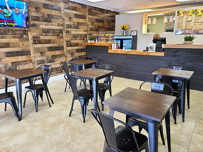 Industrial-chic meets backyard comfort in this cozy dining space where reclaimed wood walls tell you they're serious about rustic authenticity.