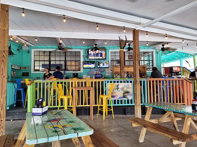 Colorful railings, string lights, and weathered wood create that perfect "I'm on vacation" vibe, even when you're just on your lunch break.
