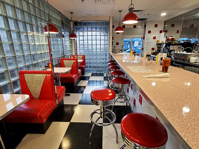 Red vinyl booths and chrome stools aren't just seating—they're front-row tickets to the greatest show on earth: breakfast in America.