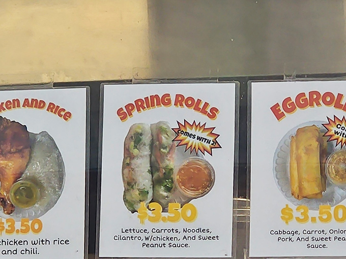 The menu board tells a delicious story in three acts: chicken and rice, spring rolls, and egg rolls—simple perfection that needs no Broadway production values to shine.