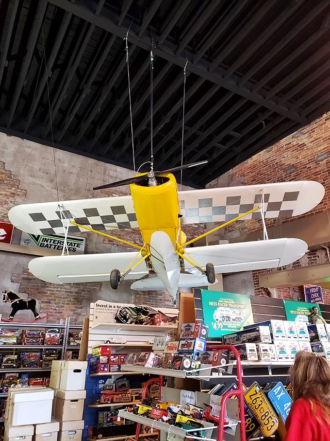 Forget modern airport hassles—this vintage yellow and checkerboard plane has been permanently cleared for takeoff in the most whimsical ceiling display imaginable.