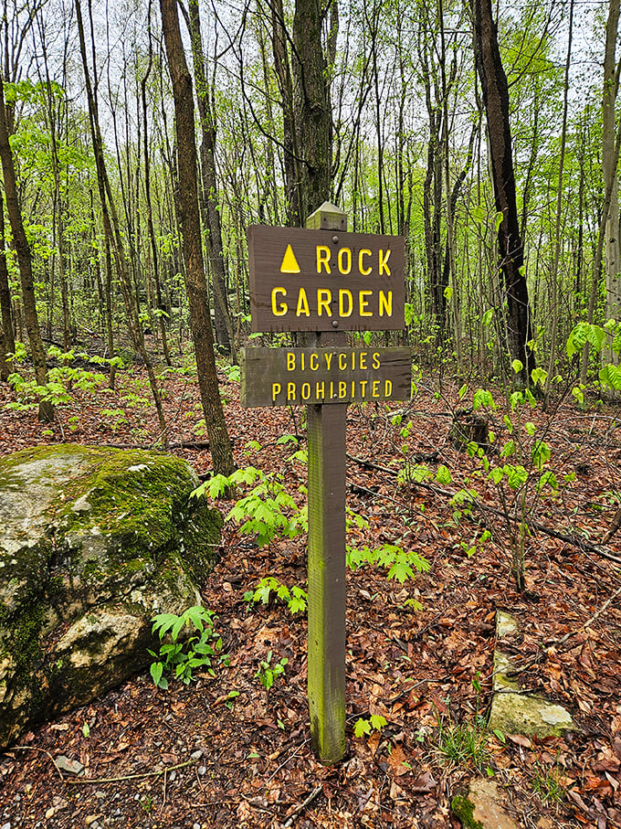 The Rock Garden trail sign stands guard at nature's playground. No bicycles allowed—as if anyone could pedal through this boulder obstacle course anyway.