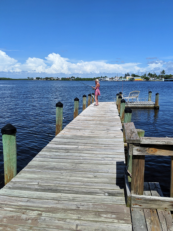 The simple joy of fishing from a weathered dock—where catching nothing still feels like winning when the view is this spectacular.
