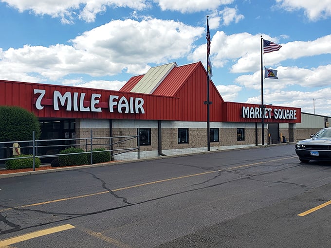 Blue skies frame the distinctive 7 Mile Fair façade, where American flags flutter above a building that houses thousands of treasures waiting to be discovered.