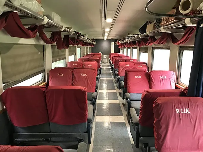 Rows of plush burgundy seats invite passengers to settle in and watch the world roll by. No middle seats, no overhead bins—just pure, civilized travel.