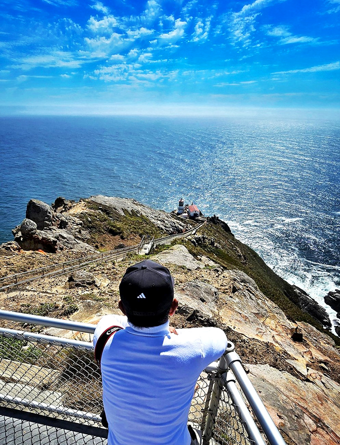 The reward for conquering those stairs? A front-row seat to the greatest show on Earth—where sky meets ocean in an endless blue embrace.