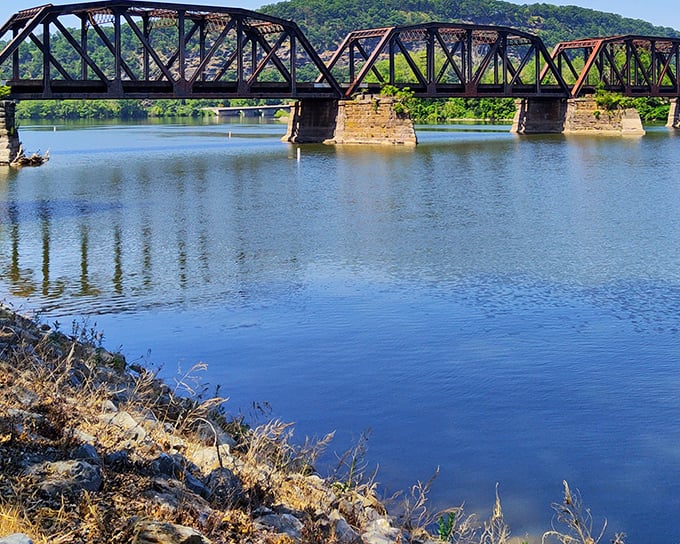 This isn't just any bridge – it's a time machine spanning both river and decades, its weathered steel trusses telling stories of countless crossings.