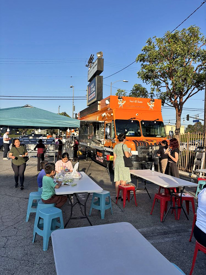 Plastic tables and folding chairs transform an ordinary parking lot into LA's most democratic dining room. Michelin stars? Who needs 'em!