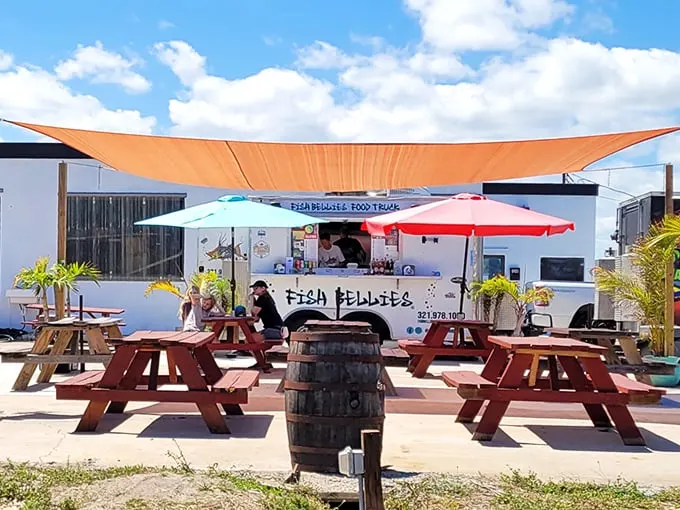 Florida dining at its most authentic – picnic tables under orange shade sails, where strangers become friends united by the universal language of "mmmmm."