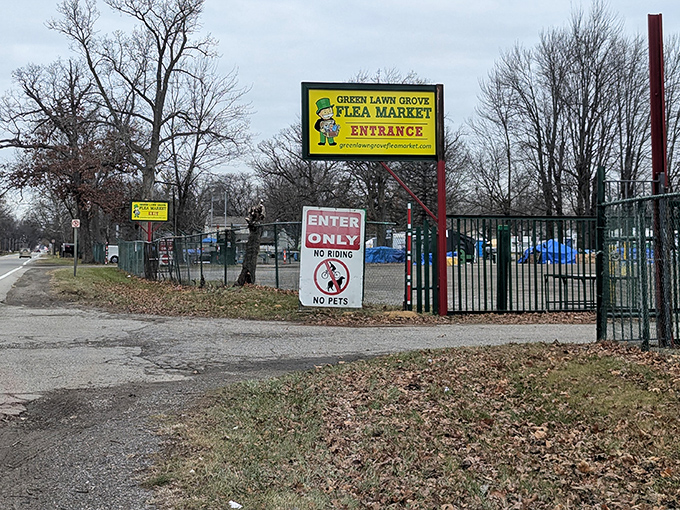 Not just an entrance—a portal to possibility. The bright yellow sign promises adventures in bargain archaeology just beyond the gate.
