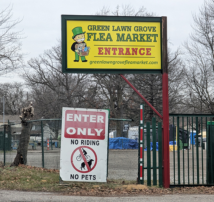 The cheerful yellow sign stands guard like a beacon to bargain seekers—complete with the universal flea market rule: leave Fido at home.
