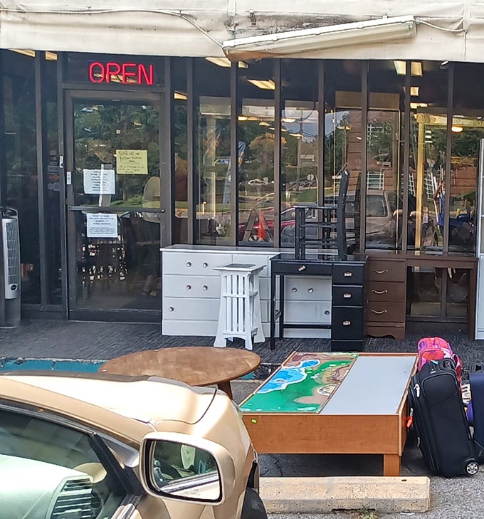 That glowing "OPEN" sign might as well say "ADVENTURE AWAITS." Furniture spilling out front offers just a taste of what's inside.