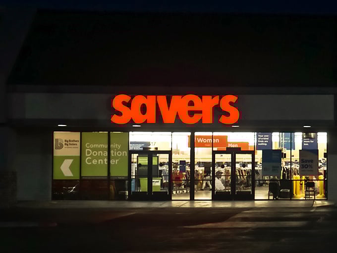 Even after hours, the Savers storefront beckons with its warm glow—like a museum of everyday artifacts that opens its doors to everyone.
