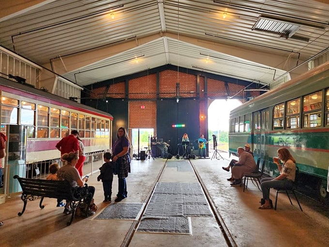Where history comes alive! Visitors gather inside the museum's spacious barn, where vintage trolleys stand ready for their next journey through time.