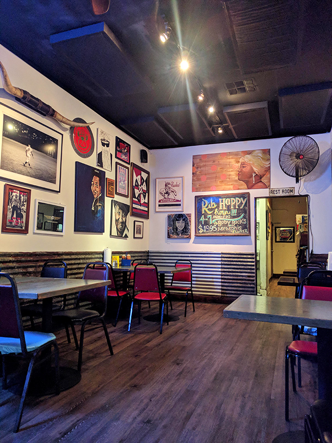 Wall-to-wall personality with music posters and corrugated metal wainscoting—this isn't corporate decor, it's barbecue with character and soul.