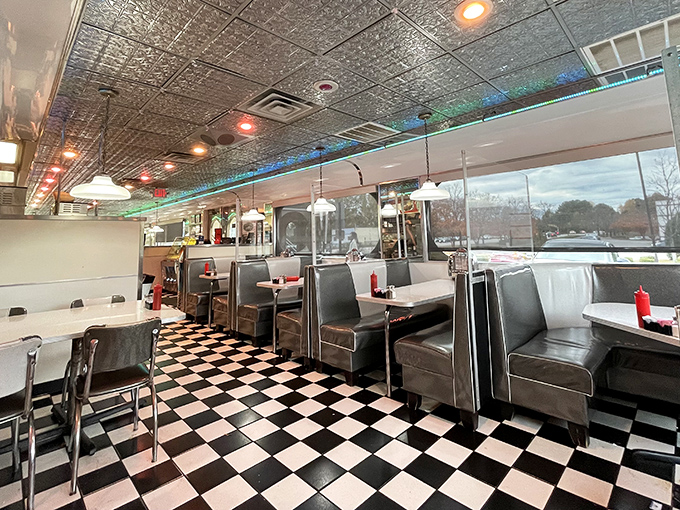 Step back in time without leaving the present. The classic black and white checkered floor and red vinyl booths promise comfort before the first bite.