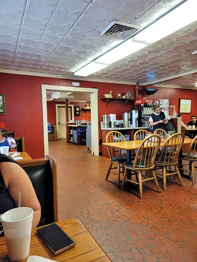 Red walls, tin ceiling, and wooden chairs that have witnessed countless barbecue epiphanies. No designer required—just pure function and tradition.