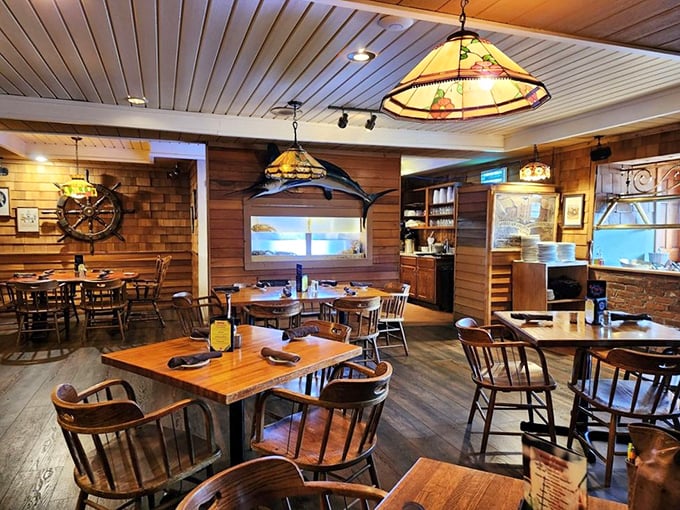 Wooden ship wheels and stained glass lamps transform this mountain restaurant into a cozy captain's quarters. The warm paneling practically whispers sea shanties as you dine.