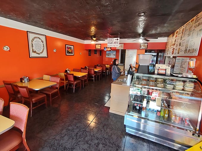 Vibrant orange walls welcome you like a warm tropical embrace. This no-frills dining room lets the food take center stage.