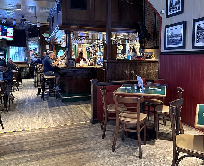 Inside, worn wooden floors and red wainscoting create that perfect Baltimore alchemy – equal parts comfort, character, and neighborhood charm.