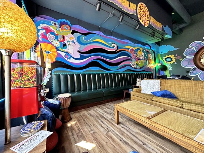 Step inside and you're transported to a hippie haven where flowing murals, vintage furniture, and kaleidoscopic colors create the perfect pizza paradise.