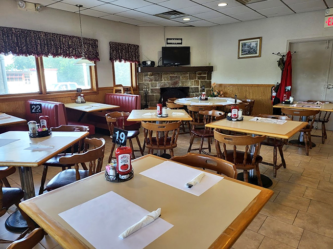 Classic diner charm at its finest—wooden tables, red booths, and that stone fireplace that makes waiting for your breakfast feel like visiting Grandma's.