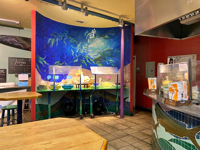 The vibrant underwater mural makes you feel like you're dining beneath the sea—appropriate considering what's about to land on your plate.