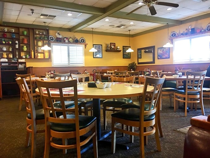 Cozy wooden tables bathed in warm yellow light create that perfect diner ambiance—where conversations flow as freely as the coffee refills.