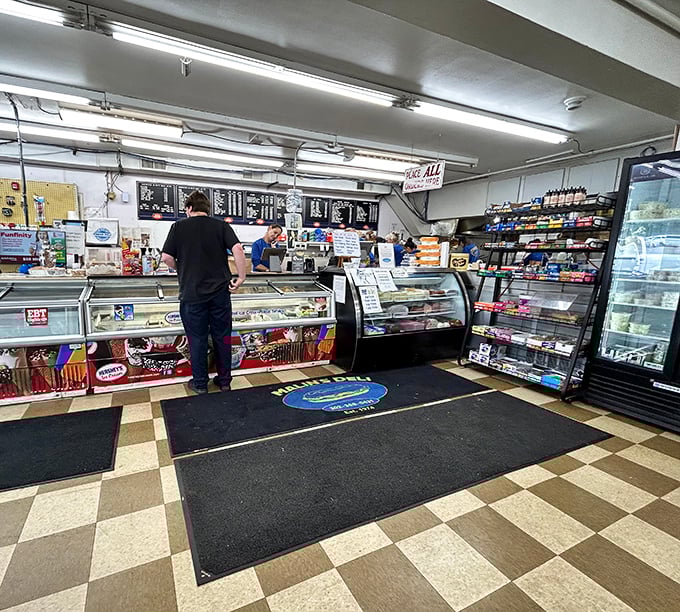Inside awaits sandwich nirvana – the classic checkerboard floor and well-stocked deli counter where culinary magic happens daily without unnecessary frills. 