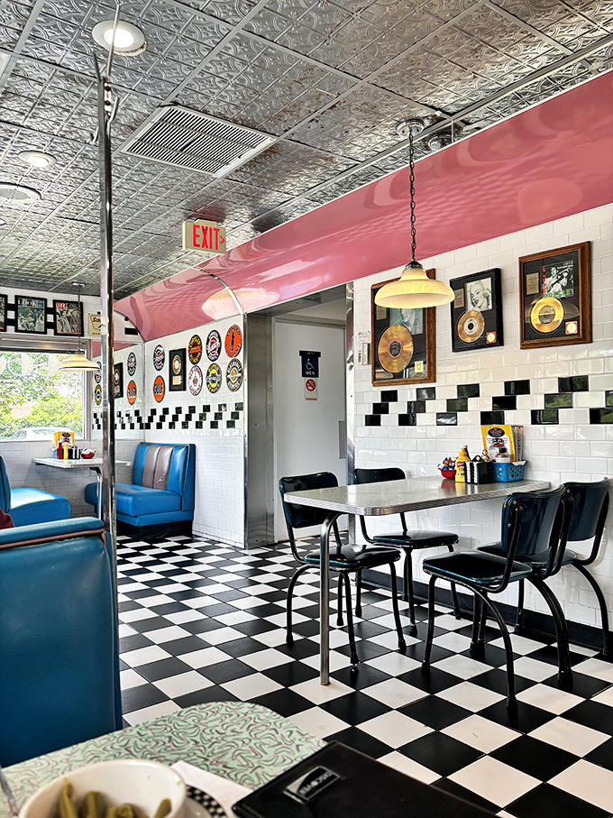 Step into a time machine where checkered floors meet blue vinyl booths. The gold records on the wall aren't just decoration—they're conversation starters.