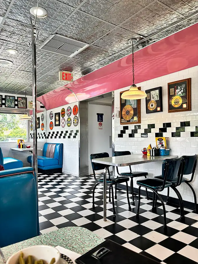 Step into a time machine where checkered floors meet blue vinyl booths. The gold records on the wall aren't just decoration—they're conversation starters.