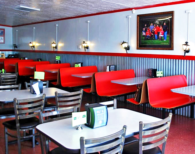 Red booths and corrugated metal walls create that perfect "focus-on-the-food" atmosphere that serious BBQ joints have mastered.